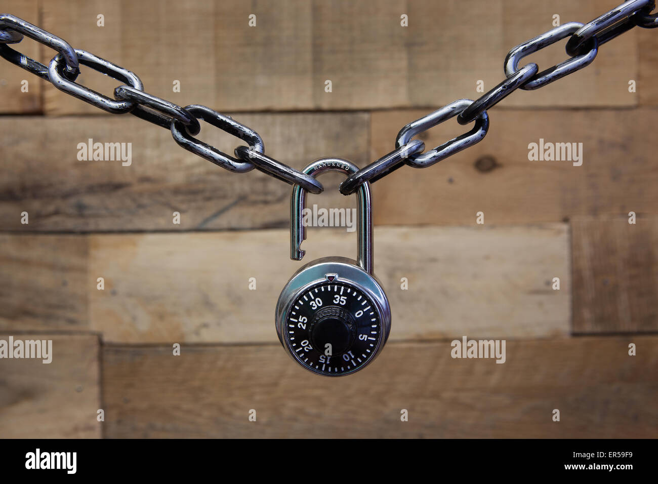Combination lock and chain on a rustic wooden background Stock Photo ...