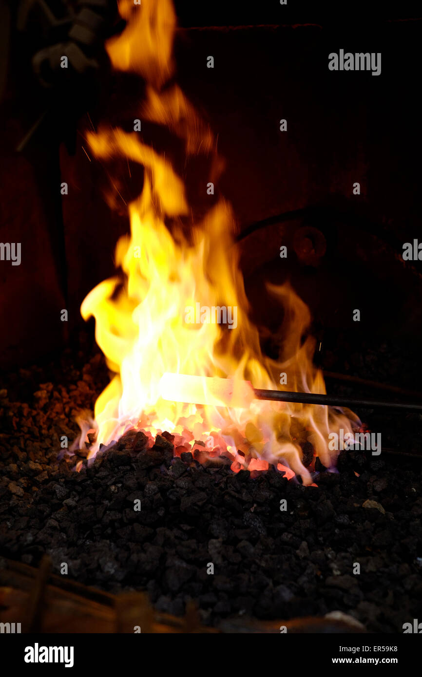 roaring flames as a blacksmith is at work in his forge in southsea ...