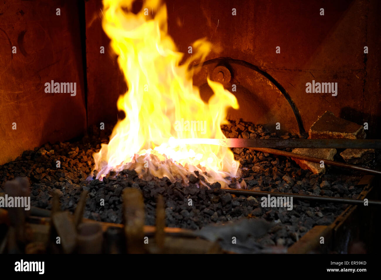 roaring flames as a blacksmith is at work in his forge in southsea ...