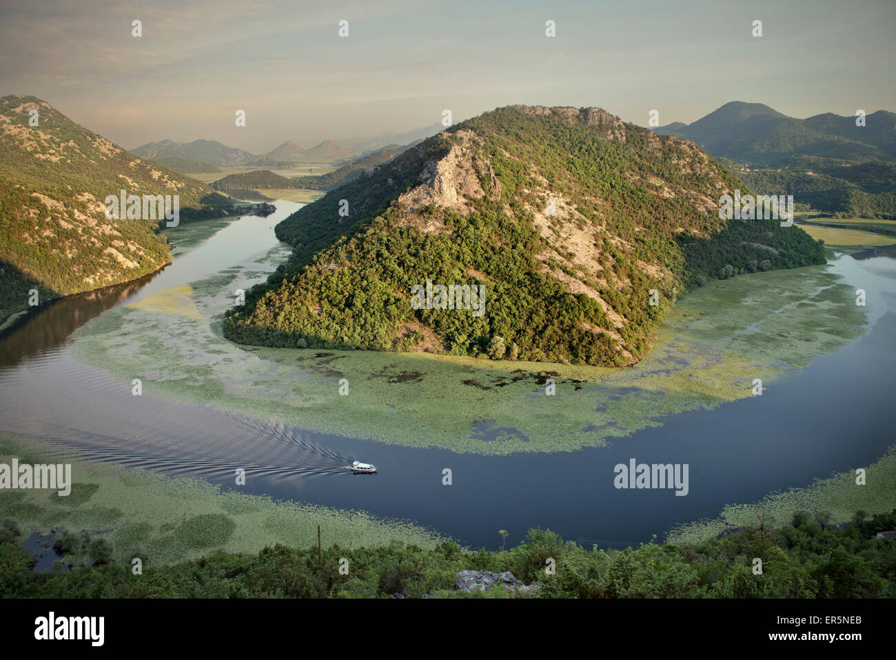 View of the river bend of the Rijeka Crnojevica river with boat, Lake Skadar National Park ...