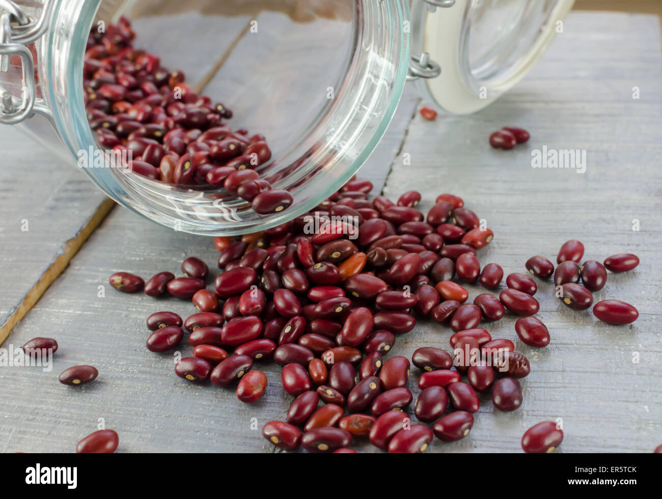 dried red kidney beans tumbling out of a glass jar Stock Photo - Alamy