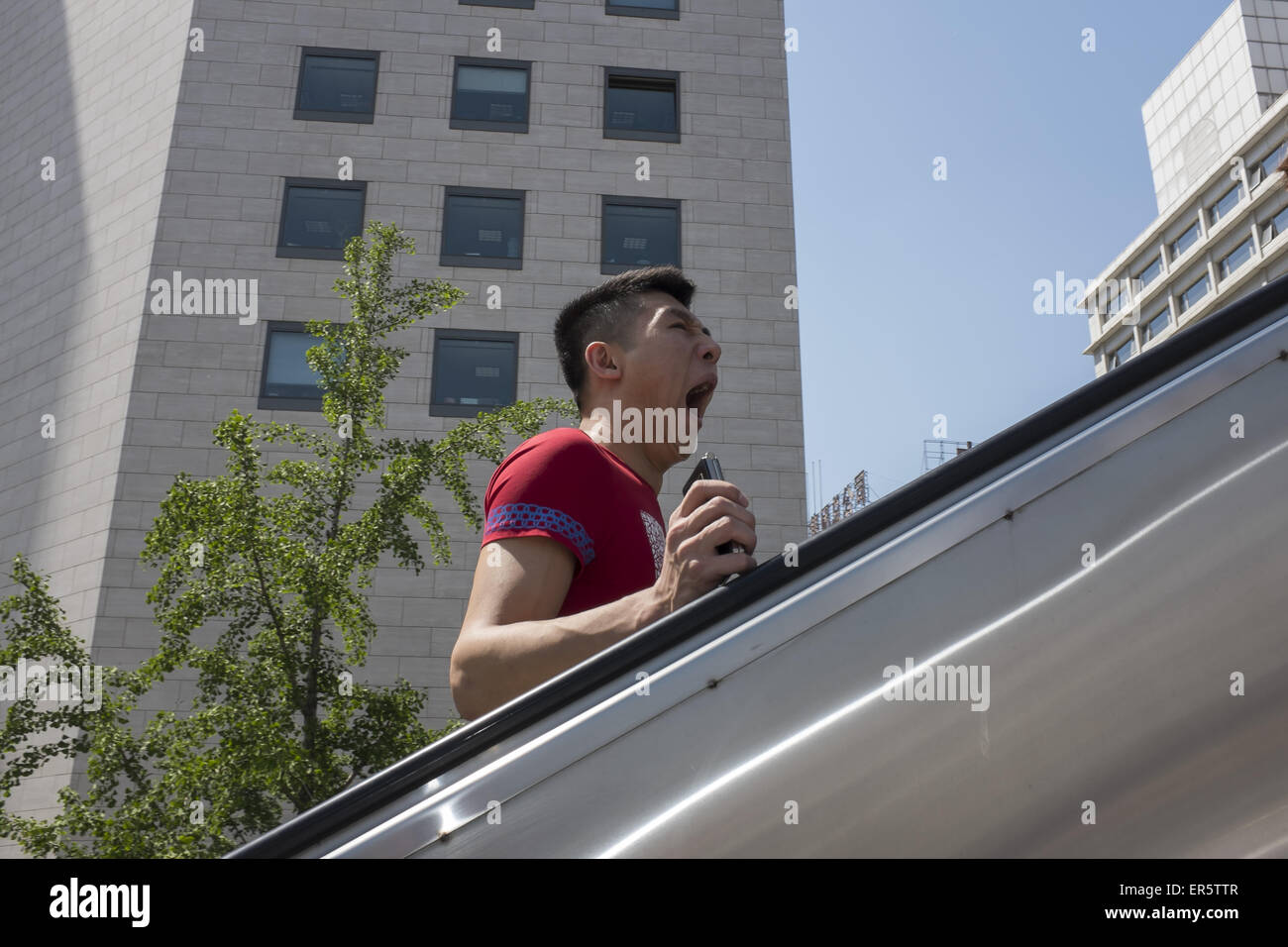 April 25, 2015 - a man walks in the hot noon and takes a great yawn ...