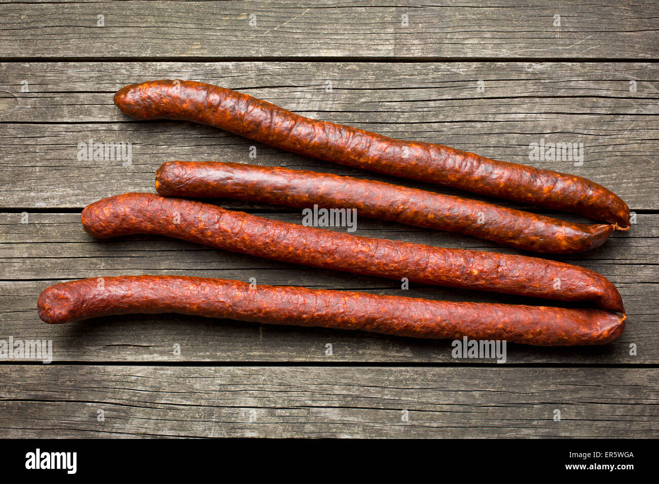 dried sausages on old wooden table Stock Photo - Alamy