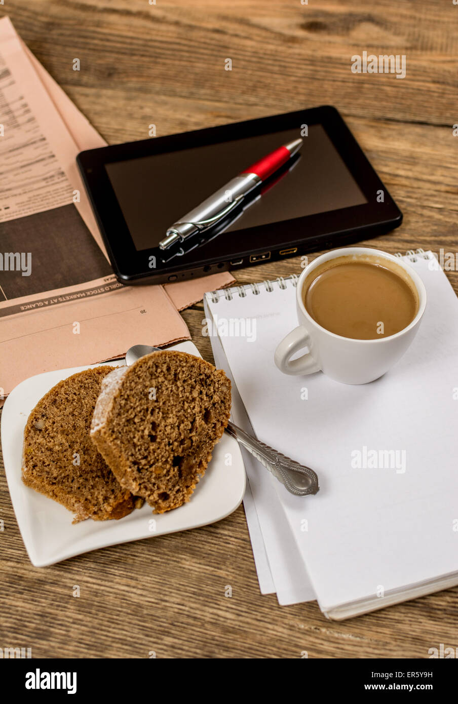 Office background with laptop coffee tablet dessert notepad newspaper ...