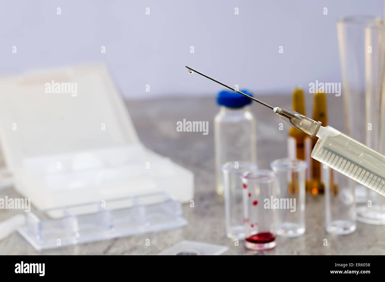 Syringe and vaccine front of a laboratory scene Stock Photo - Alamy