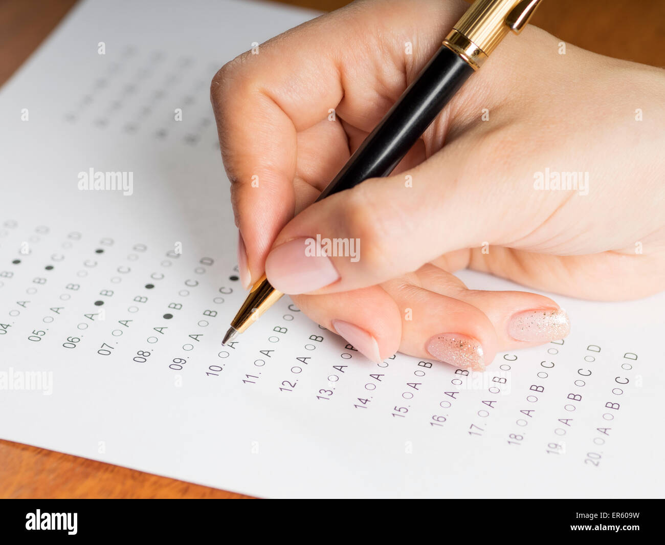 Hand of the girl fills out a questionnaire Stock Photo - Alamy