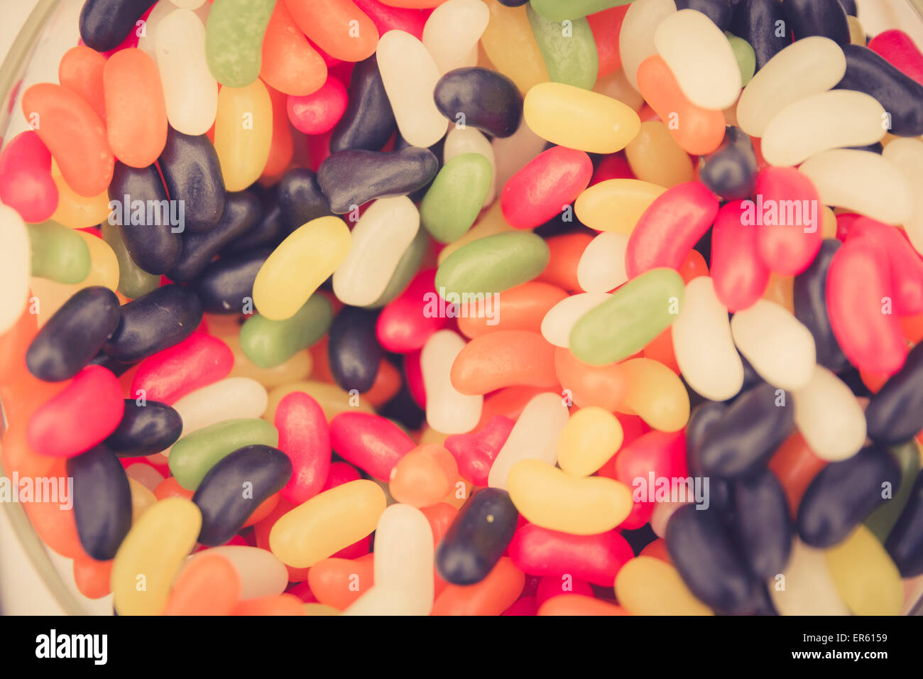 Looking down at a jar full of multi colored jelly bean sweets. The ...