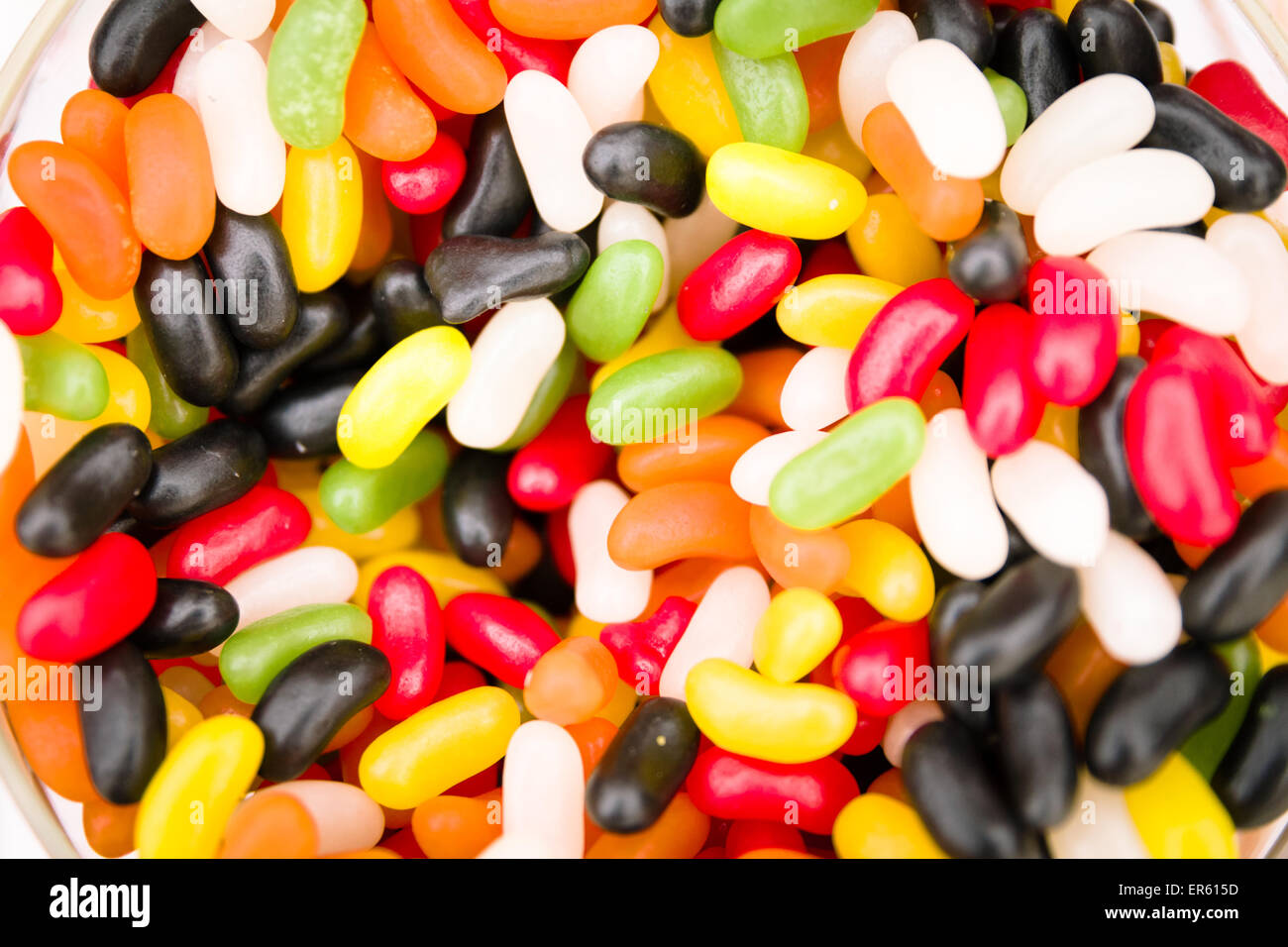 Looking down at a jar full of multi colored jelly bean sweets. The ...