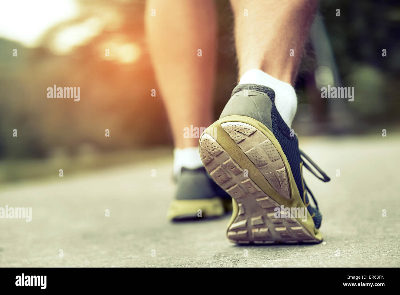 Athlete runner feet running on road Stock Photo - Alamy