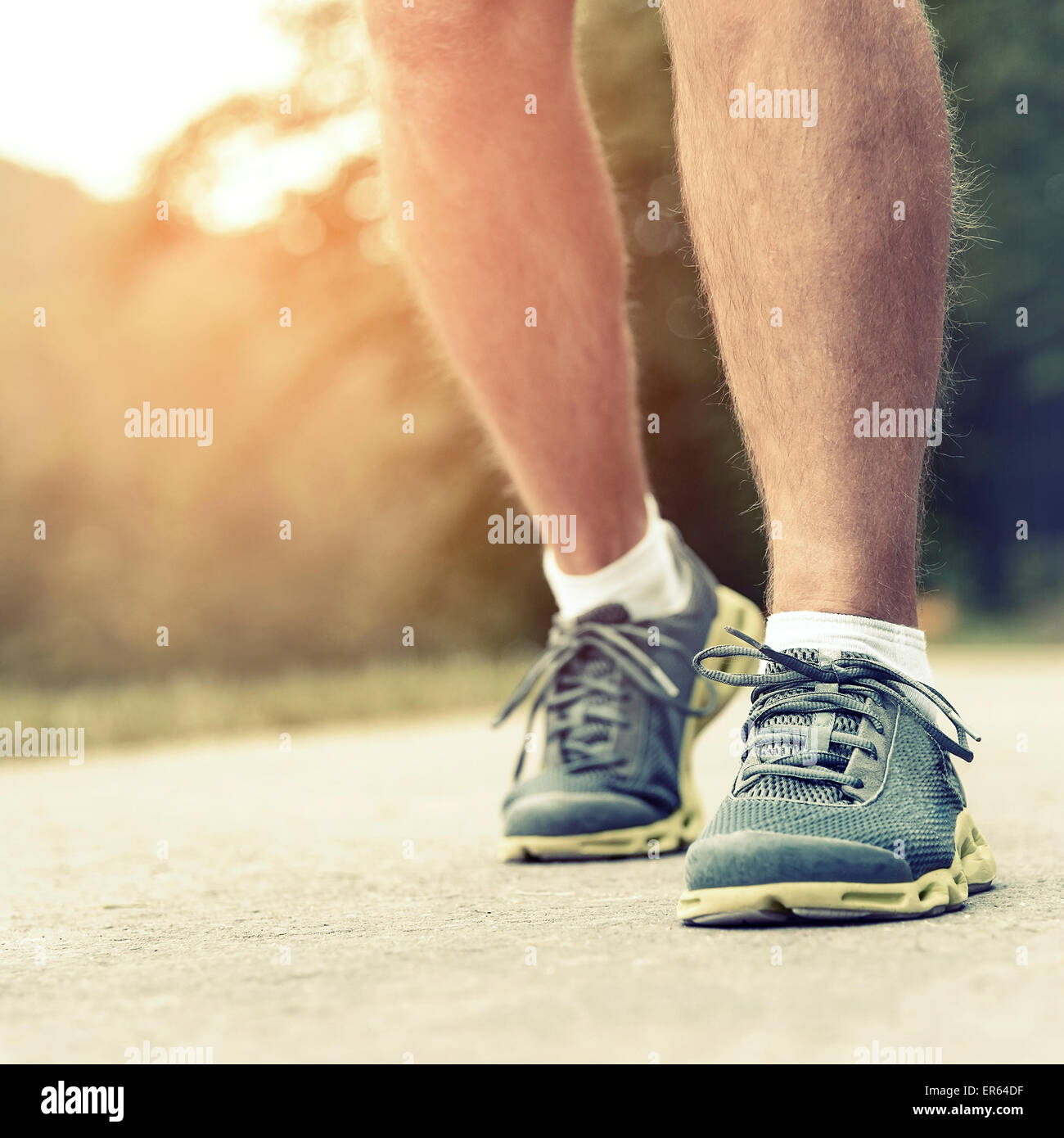Athlete runner feet running on road Stock Photo - Alamy
