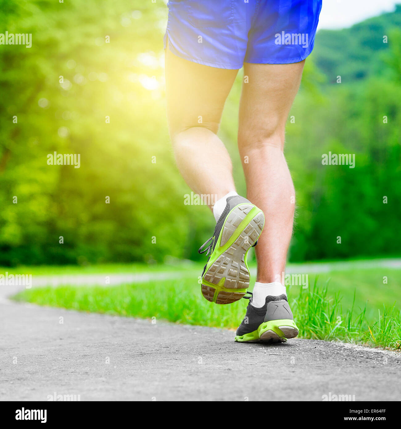 Athlete runner feet running on road Stock Photo - Alamy