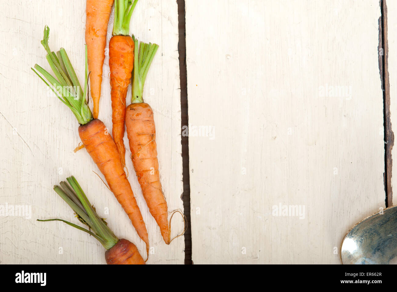 fresh baby carrots over eustic white wood table Stock Photo - Alamy