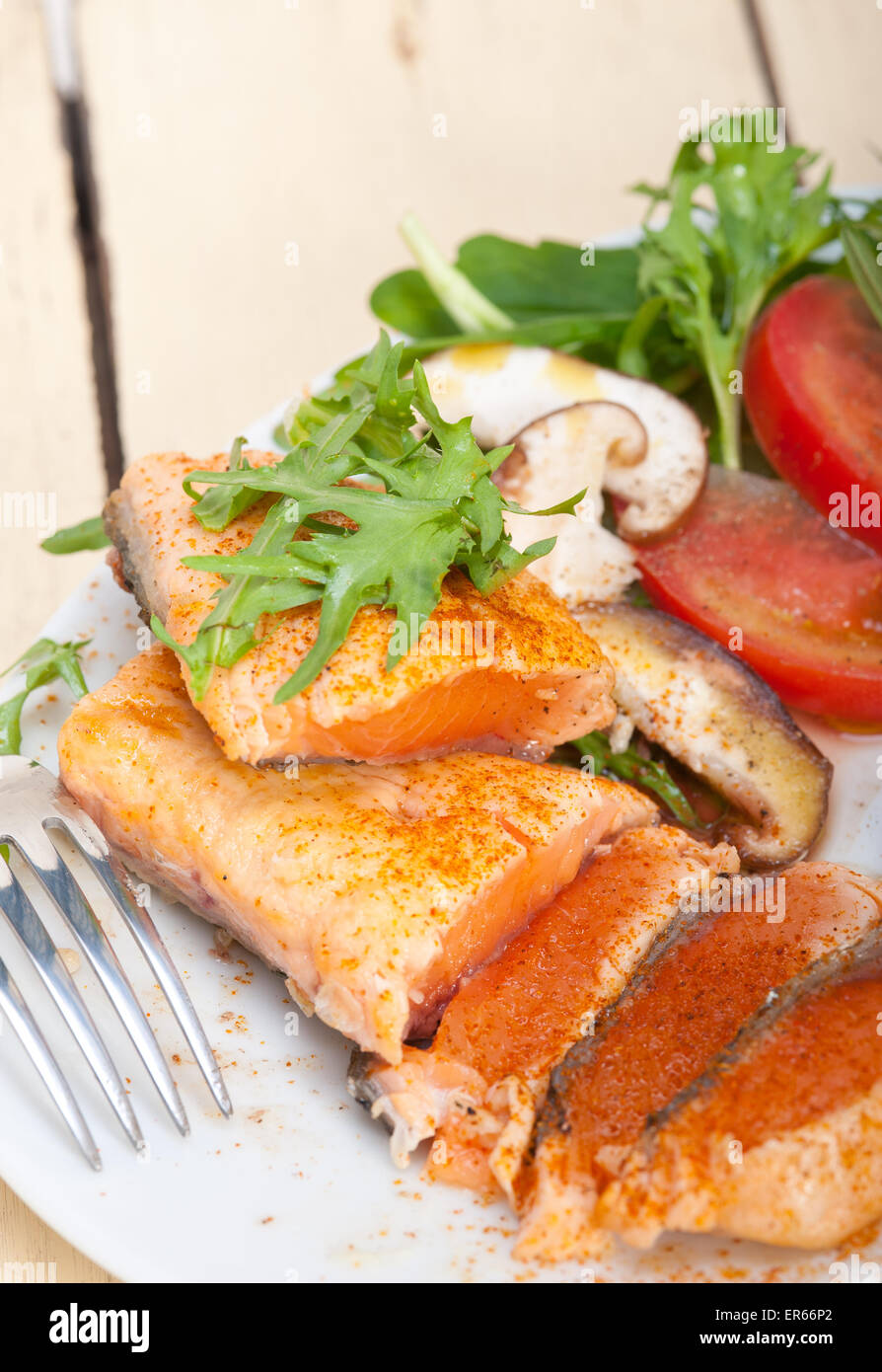 grilled fresh samon filet with vegetables salad tomato arugula ...