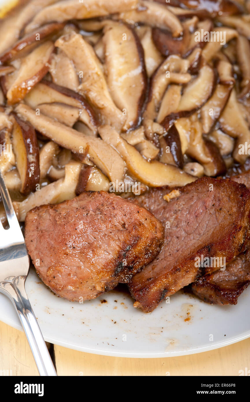 venison deer game filet tenderloin and fresh wild mushrooms Stock Photo ...