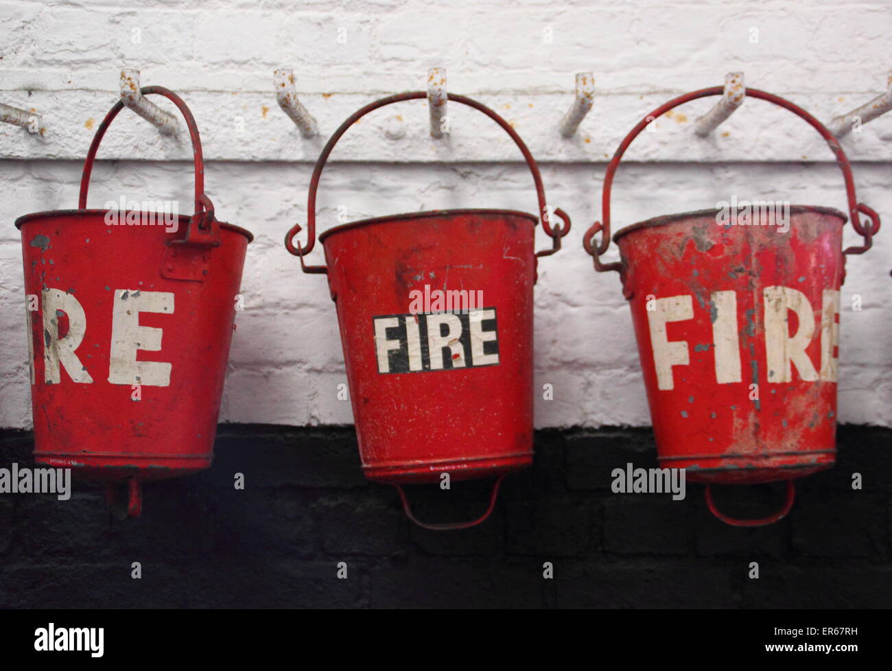 A row of vintage fire buckets hang in a row, England, UK Stock Photo ...