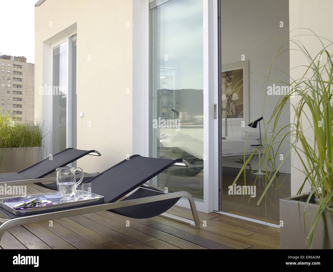 beach chairs in an elegant terrace facing a living room Stock Photo - Alamy