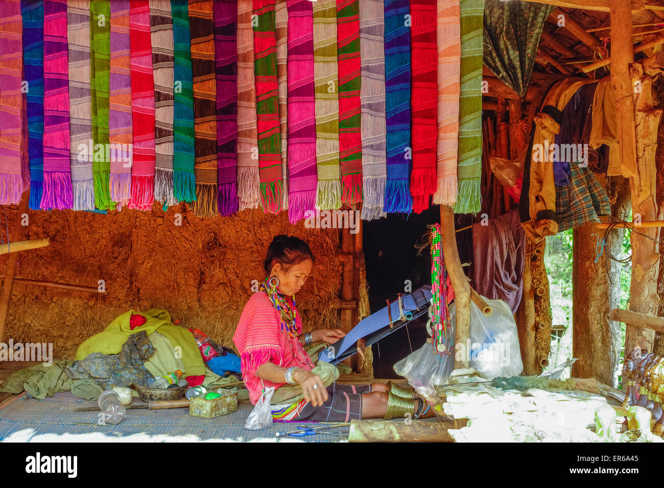 Woman from Palong tribe with traditional clothes, working on a loom ...