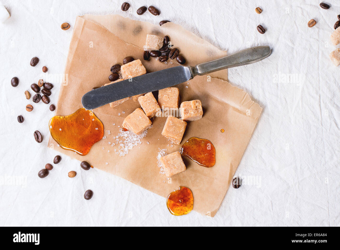 Fudge candy, coffee beans and caramel on baking paper, served over ...