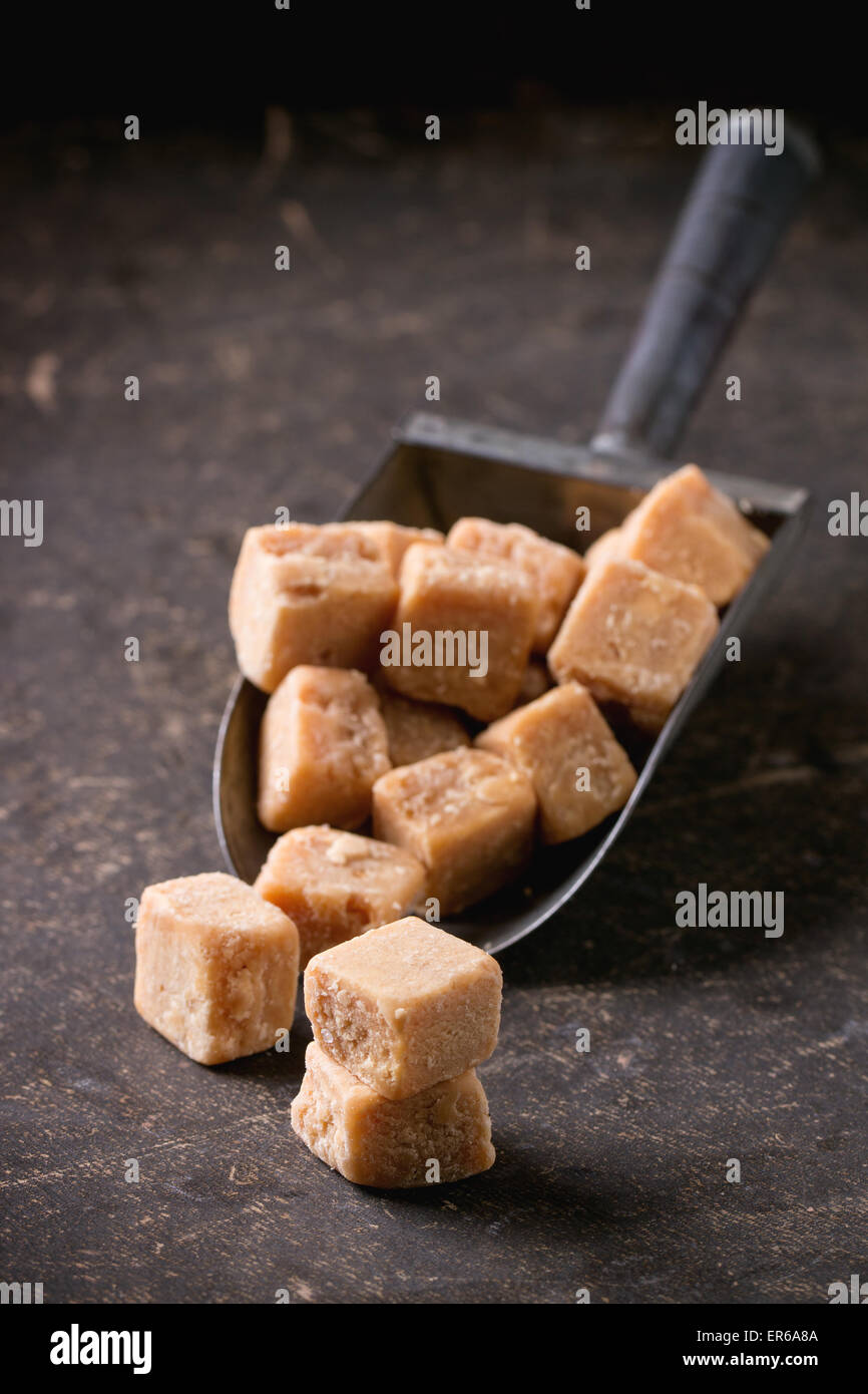 Vintage pastry scoop with fudge candy over dark background Stock Photo ...