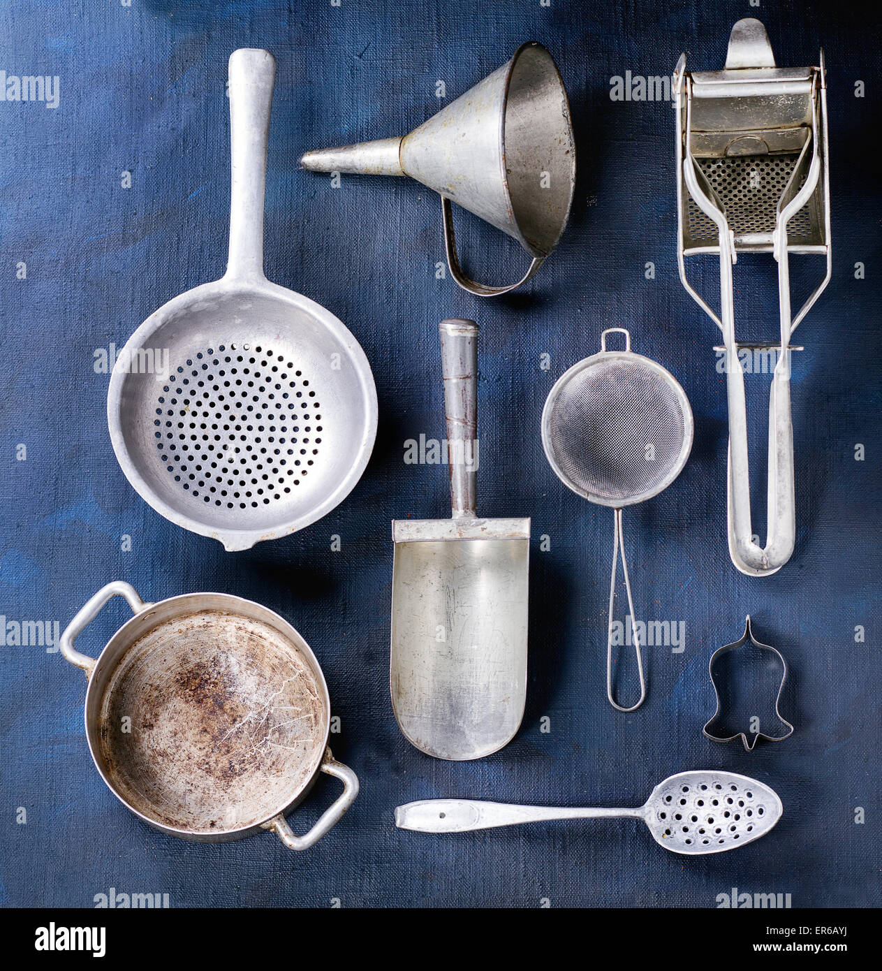 Set of vintage aluminum cookware over dark blue canvas as background ...