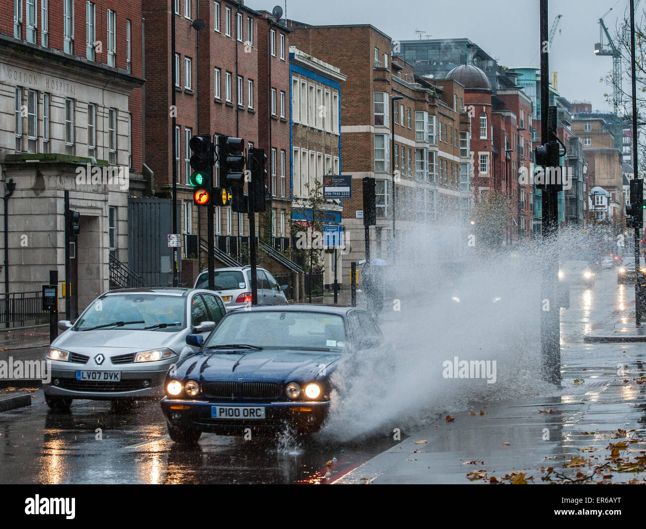 A car drives through a large puddle on London's Vauxhall Bridge Road ...