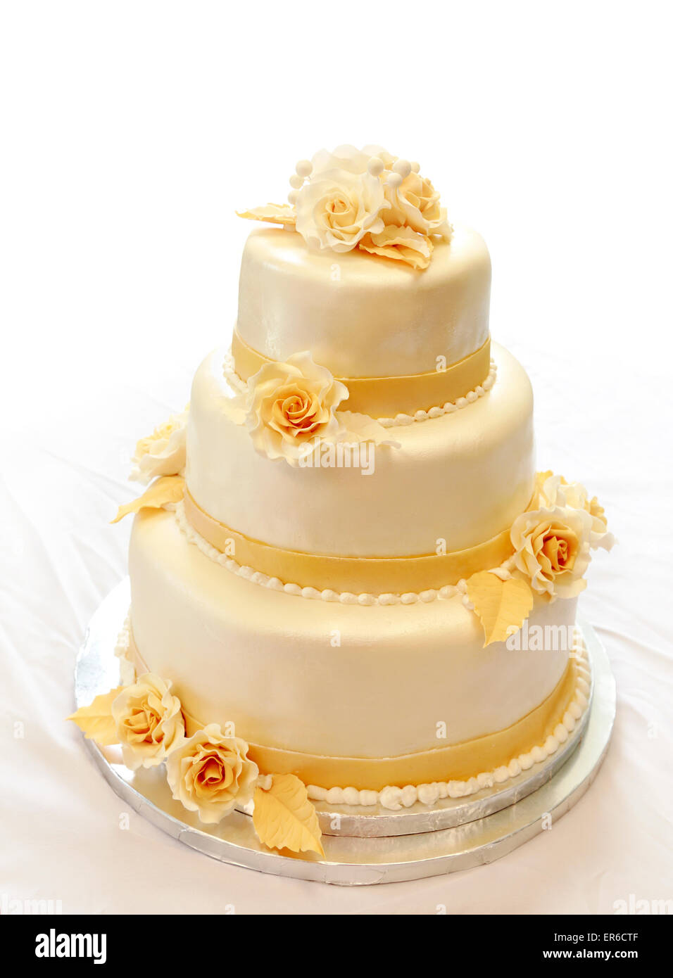 Wedding cake. 3-tiers covered in ivory fondant sprayed with pearl spray ...