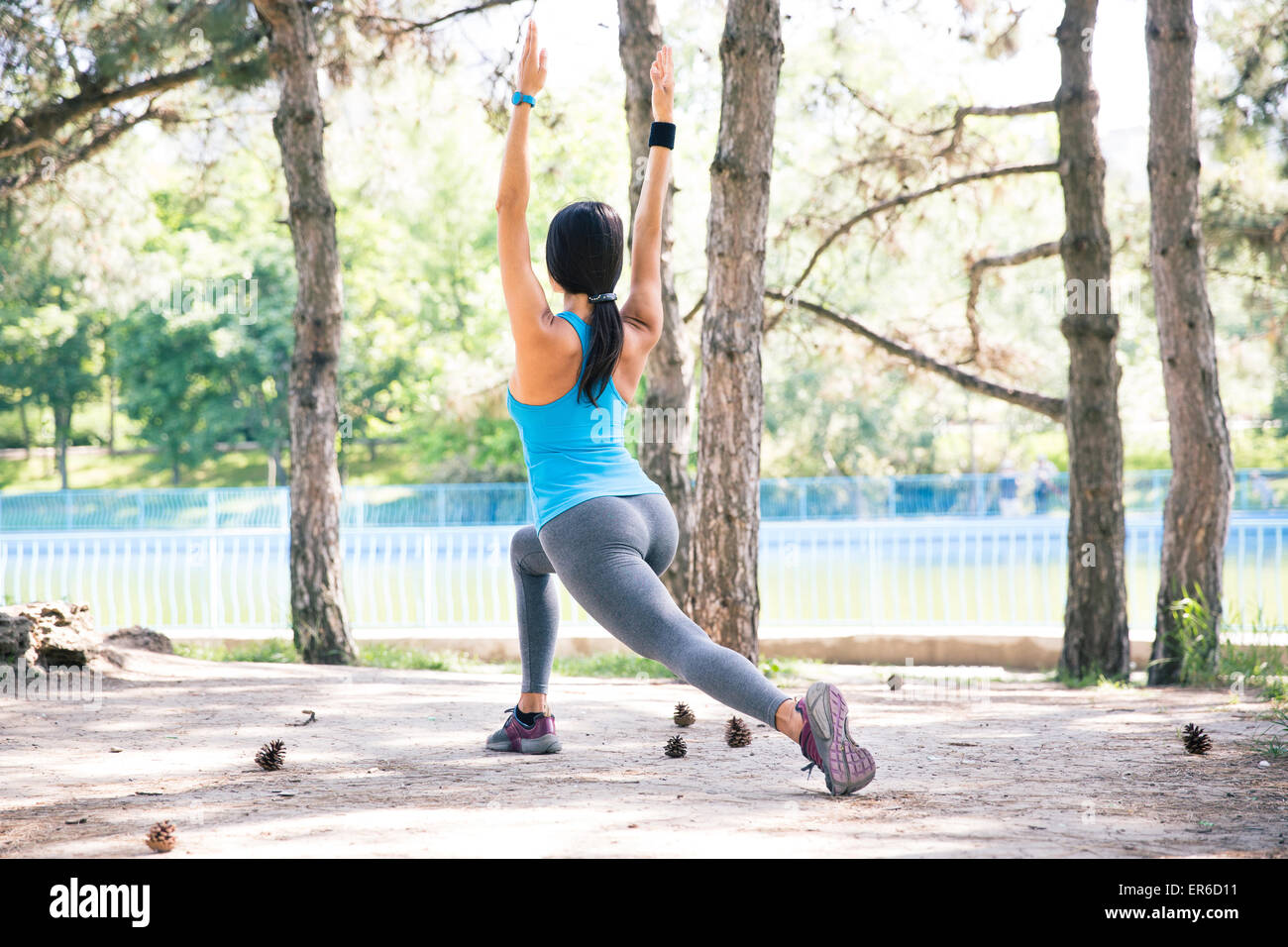 Back view portrait of a sporty woman stretching outdoors in park Stock ...