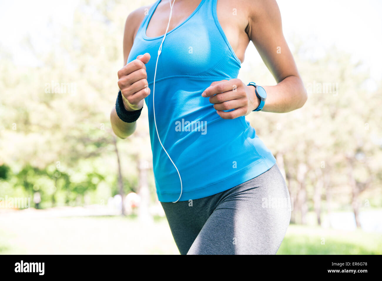 Closeup image of a woman running outdoors in park Stock Photo - Alamy