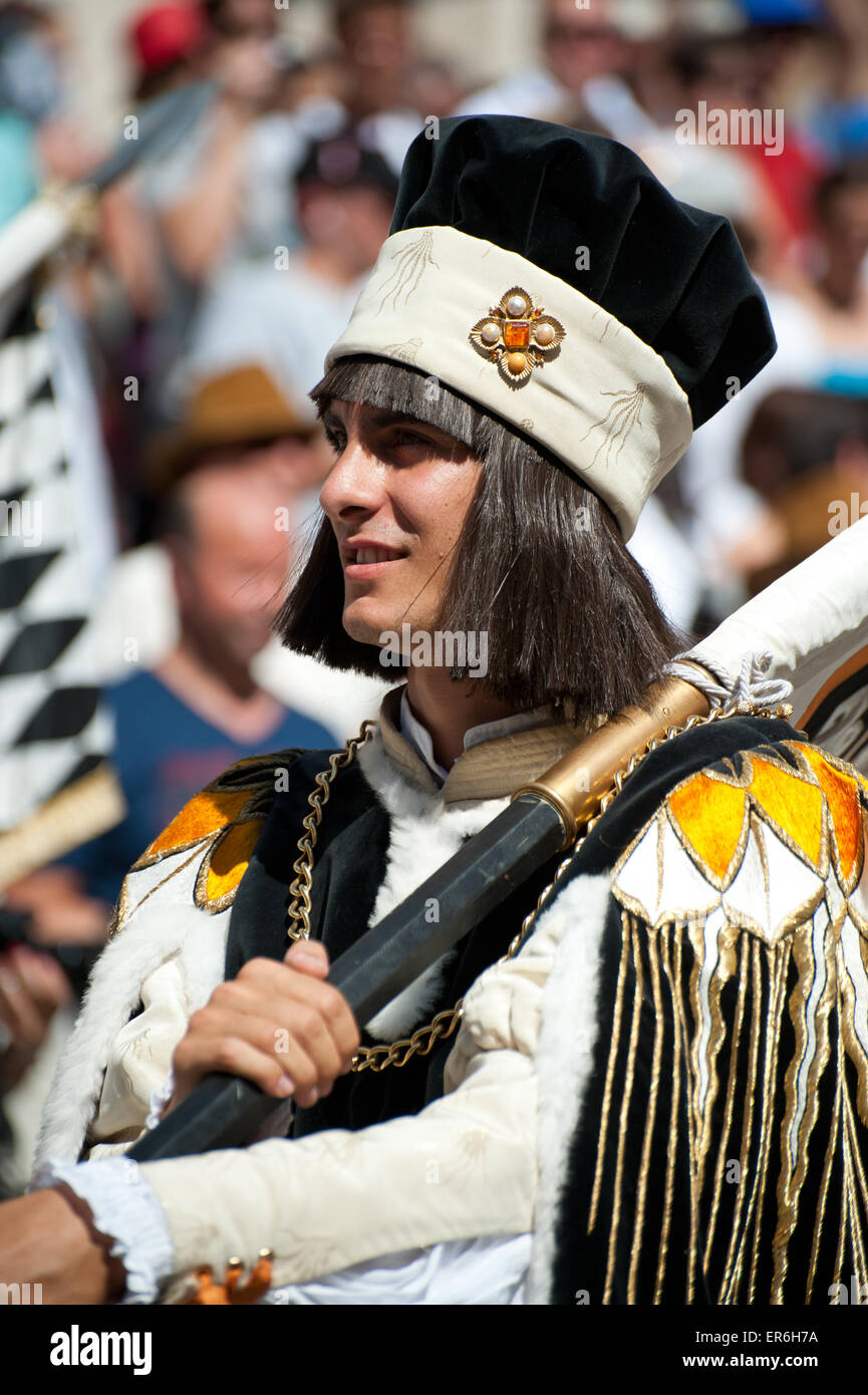 man in medieval costume of Contrada della Lupa at Corteo Storico before ...