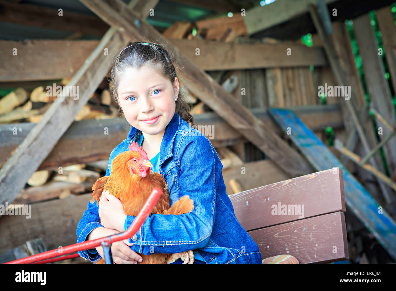 little girl with a hen in front of the farm Stock Photo - Alamy