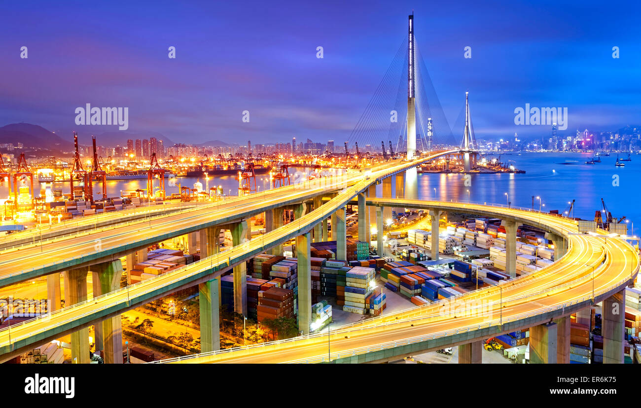 Container Cargo freight ship with working crane bridge in shipyard ...