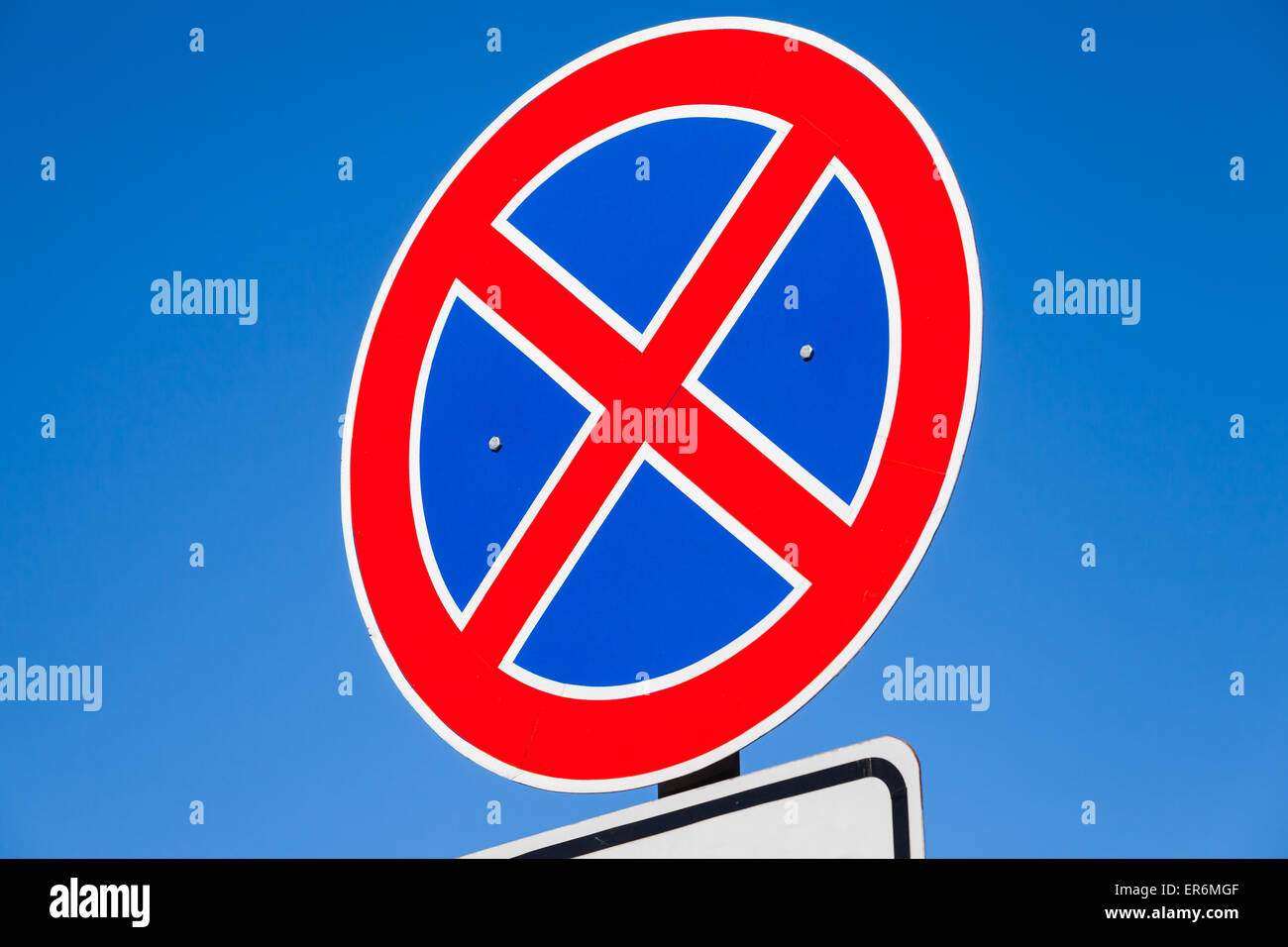 Round road sign against blue sky, standing is prohibited Stock Photo ...