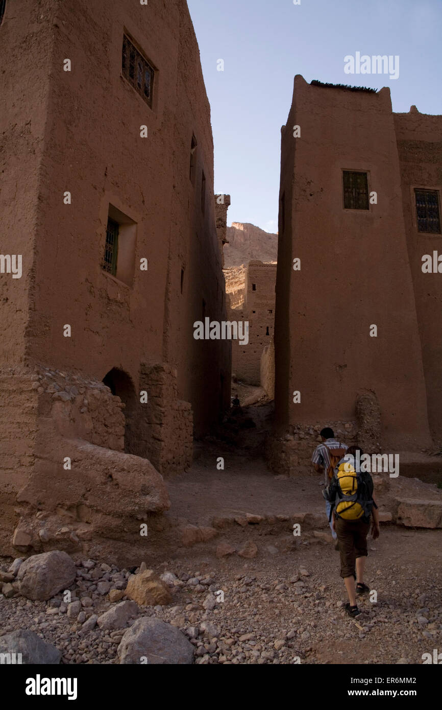 Backpacker walks through a Moroccan Village near Todra Gorge, Morocco ...