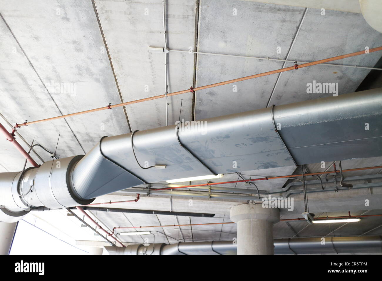 Underground park of a mall with columns and ventilation ducts Stock ...