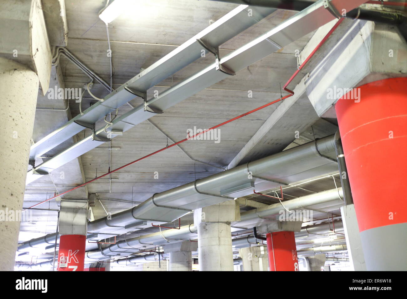 Underground park of a mall with columns and ventilation ducts Stock ...