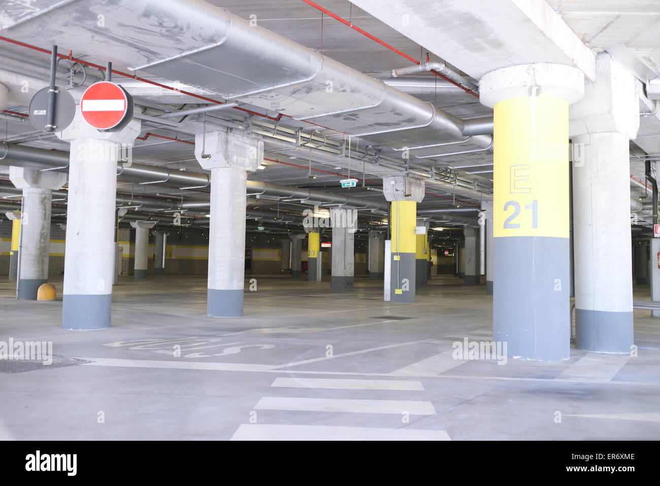 Underground park of a mall with columns and ventilation ducts Stock ...
