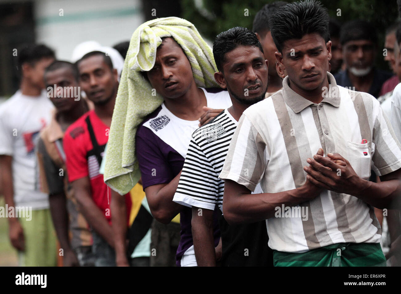 Bangladeshi migrant refugees line up to partake of bread and drink as ...