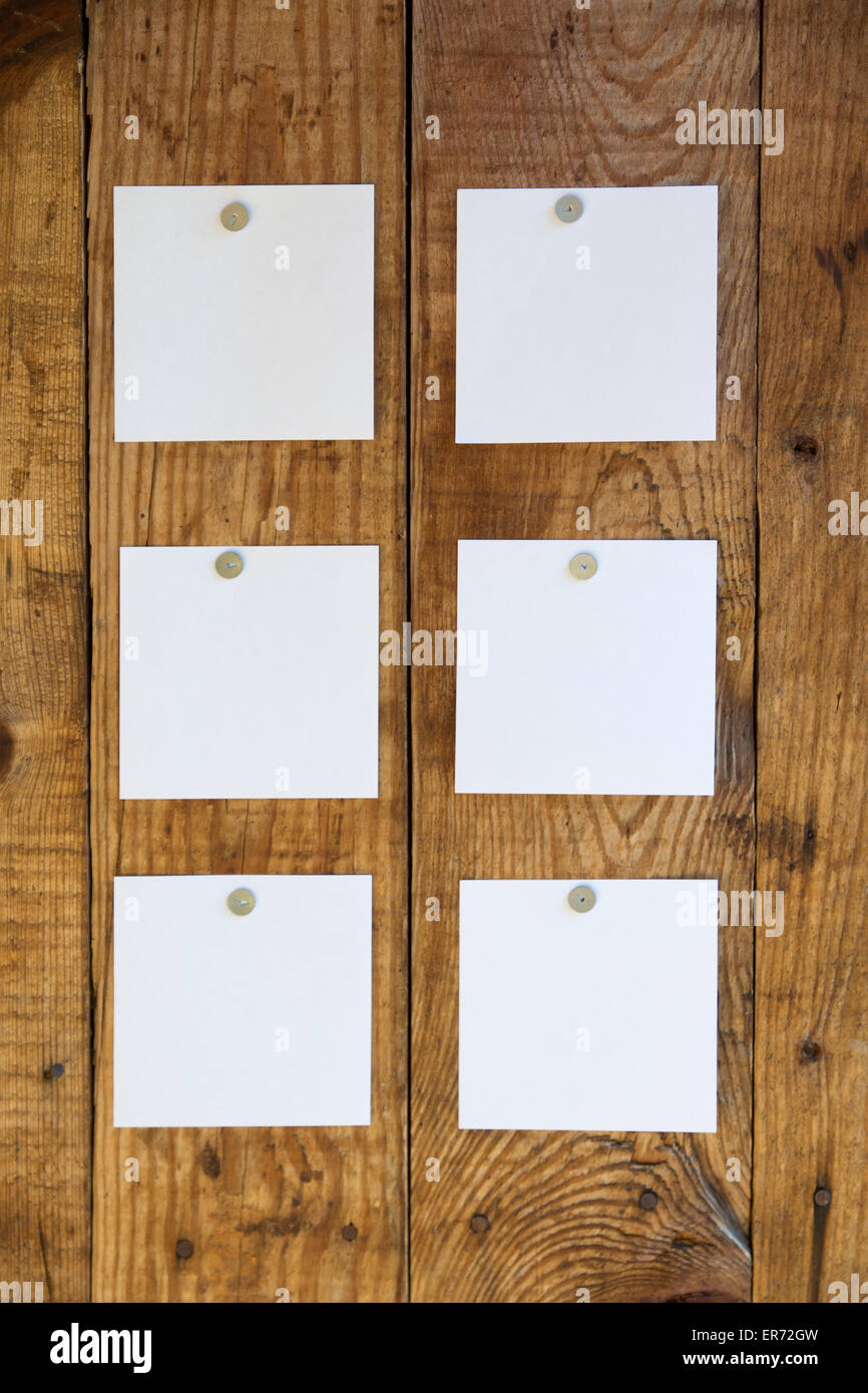 white sheets of paper attached to wooden wall with drawing pins Stock ...
