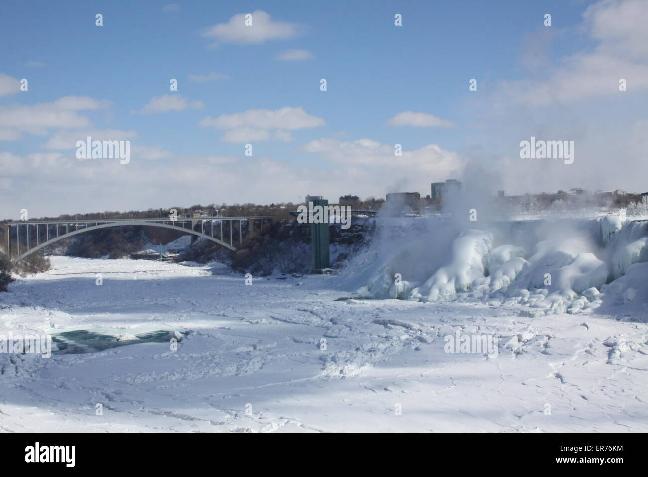 Looking down the expanse of ice filled gorge, to the ice caked boulders ...