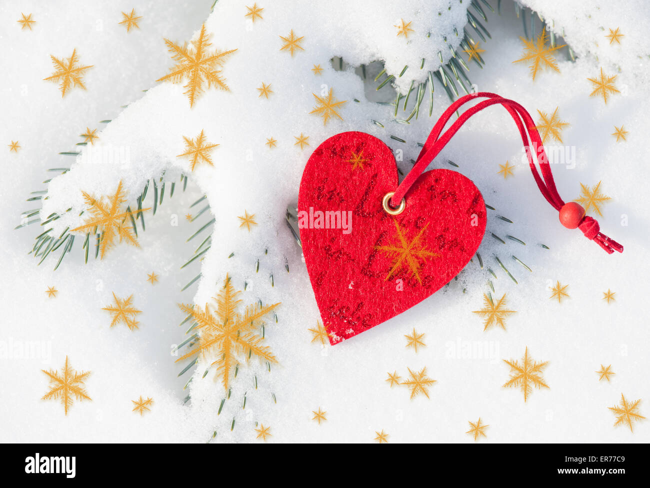 red heart toy in snowfall on fir tree Stock Photo - Alamy