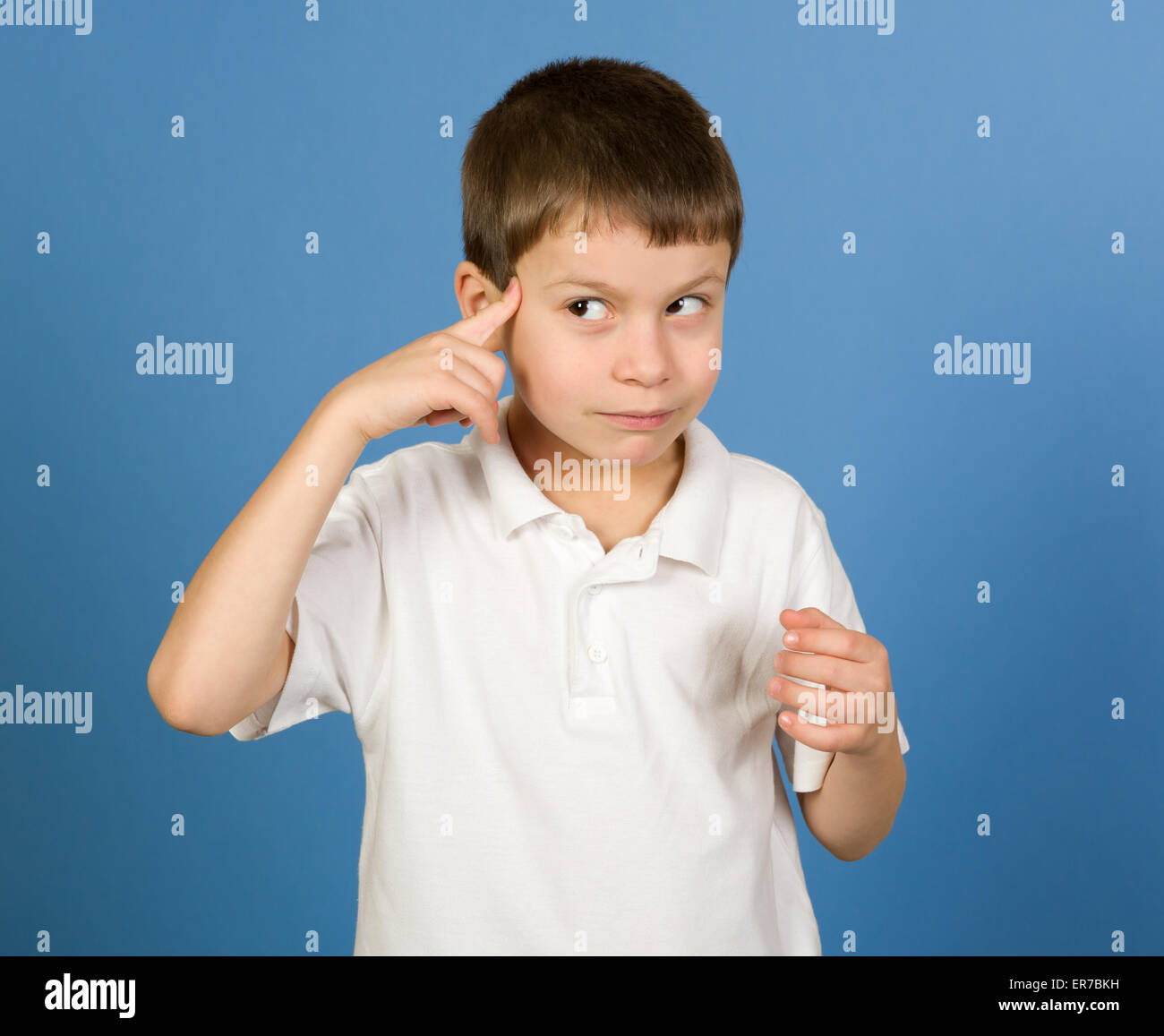 boy portrait in white shirt on blue background Stock Photo - Alamy
