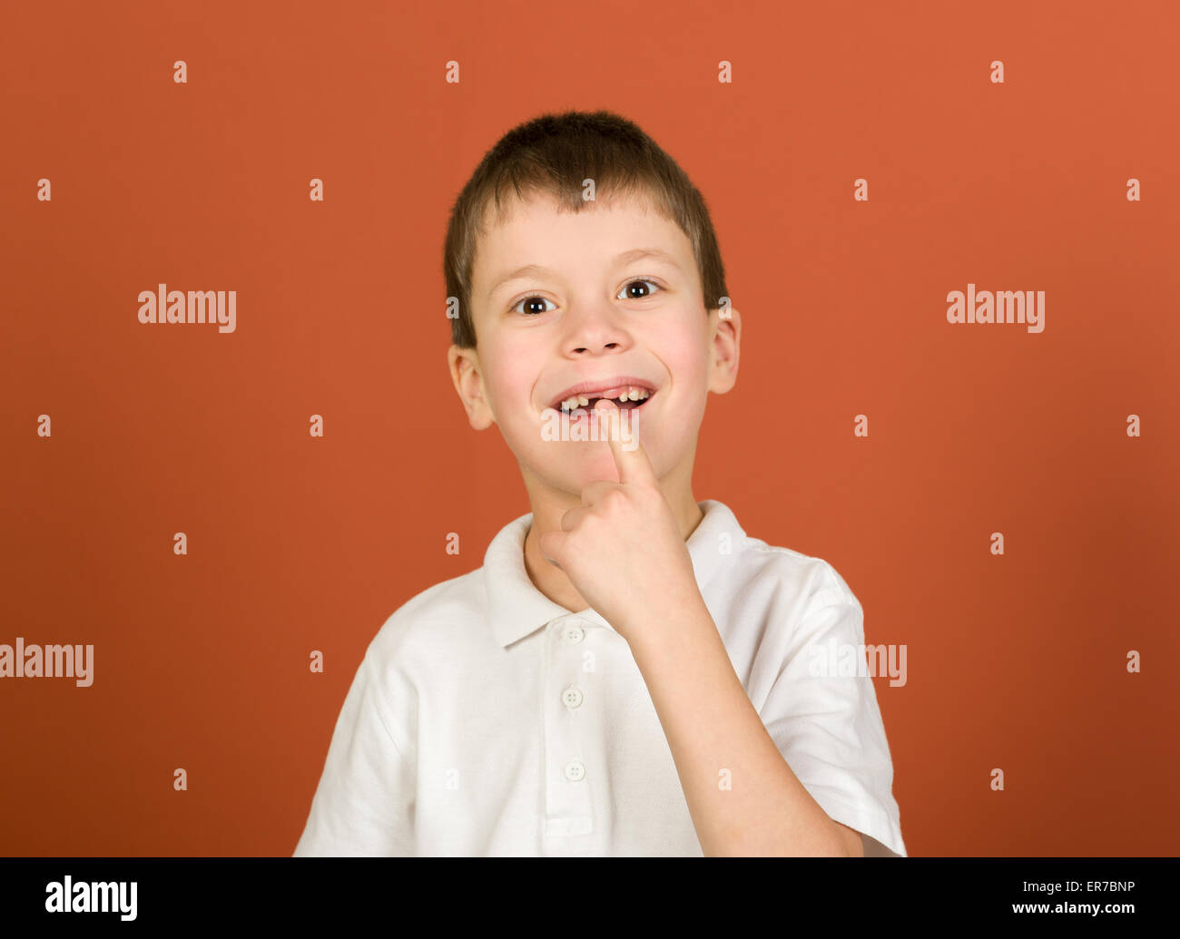 lost tooth boy portrait on brown background Stock Photo - Alamy