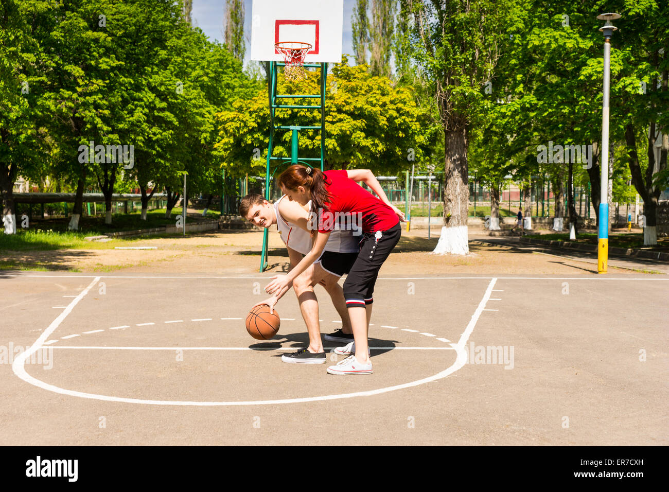 Man dribbling basketball in park hi-res stock photography and images ...