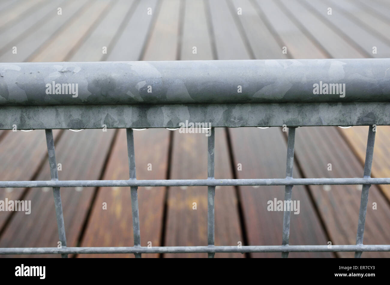 Wet railing of the wooden footway Stock Photo - Alamy