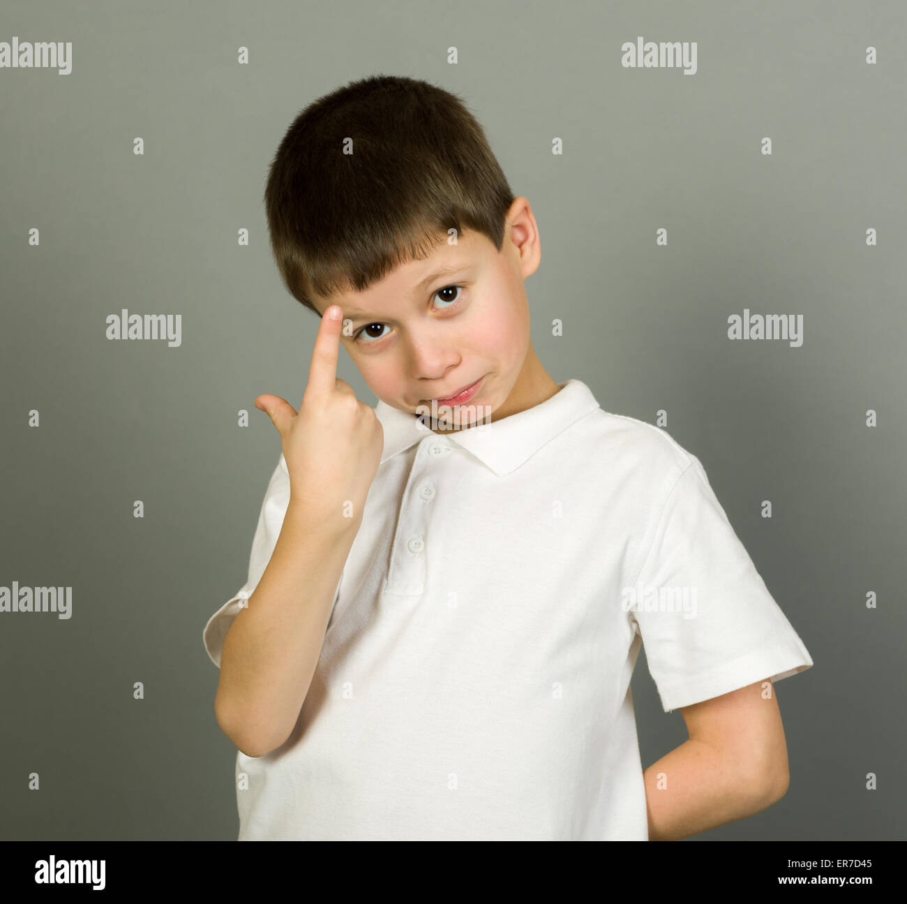 grimacing boy portrait on grey background Stock Photo - Alamy