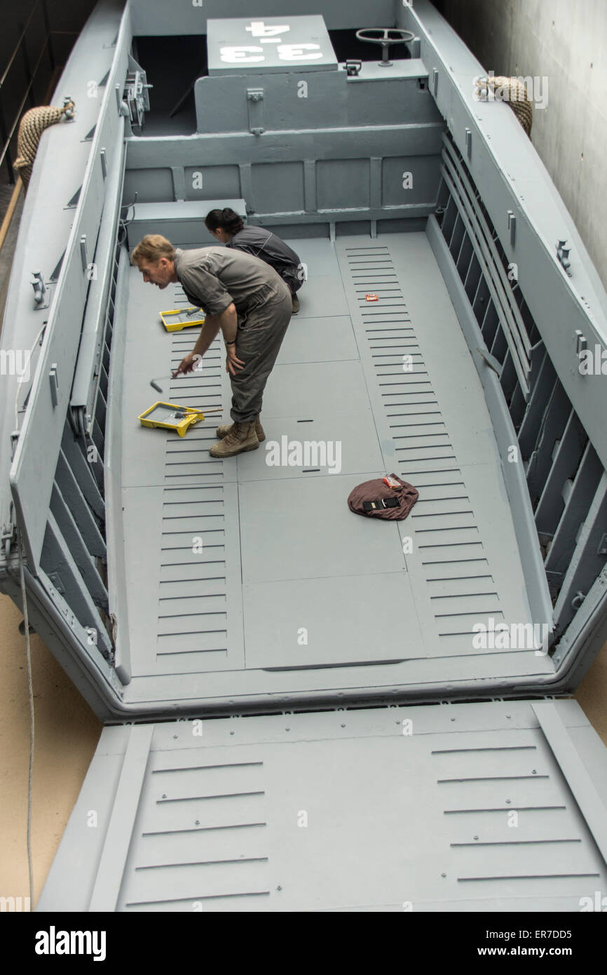 "Utah Beach" museum, Normandy, France. Workers re-paint a WWII landing ...