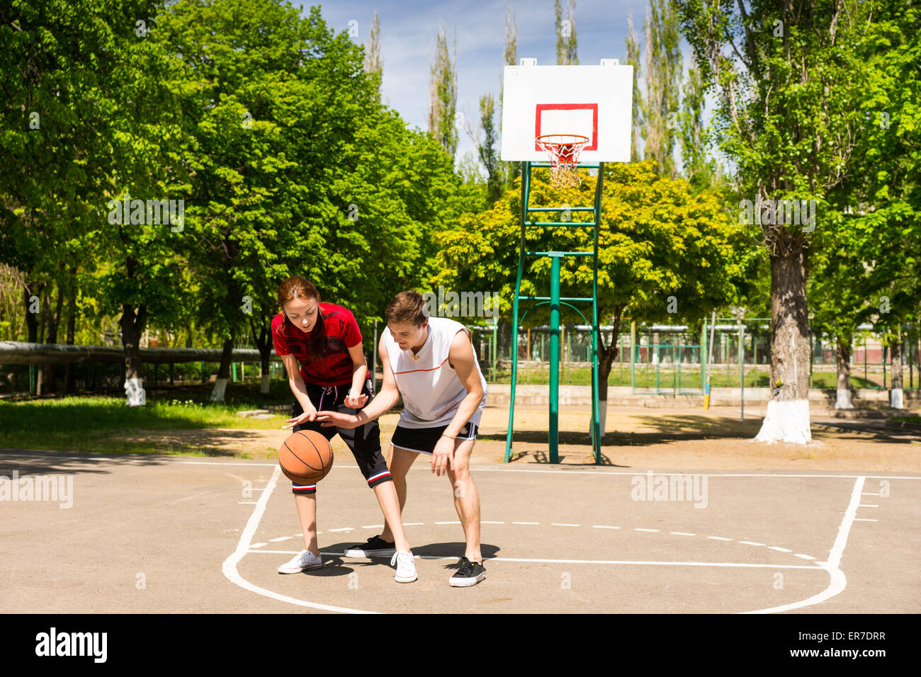 Young Athletic Couple Playing Basketball Together on Outdoor Court in ...