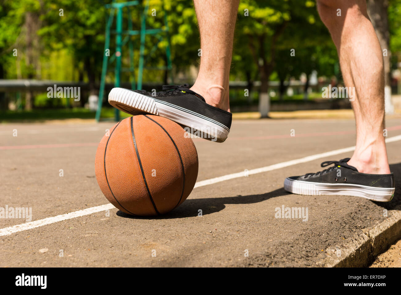 Close Up of Man Standing on Basketball Court with Foot on Top of Ball ...