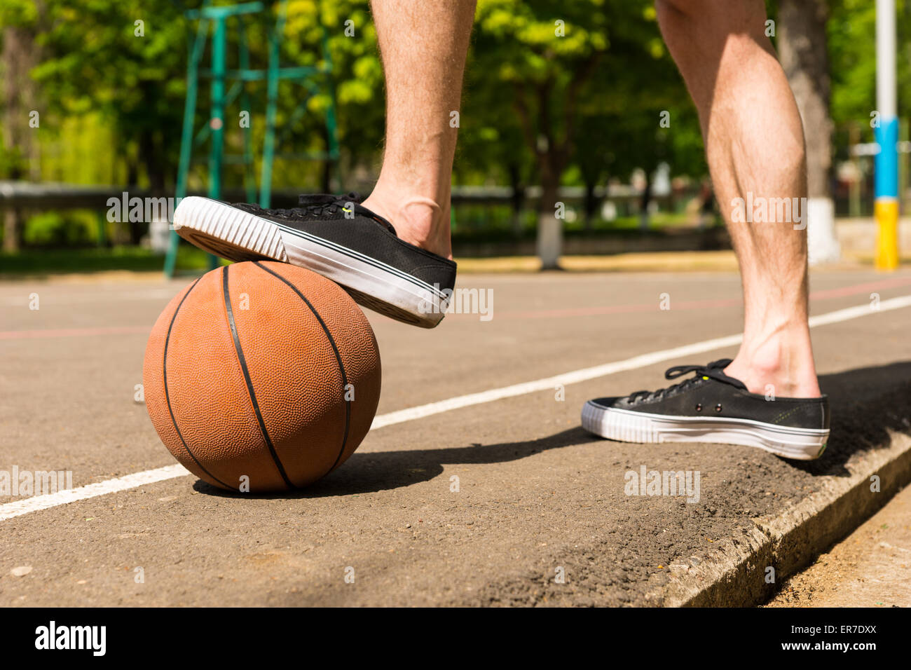 Close Up of Man Standing on Basketball Court with Foot on Top of Ball ...