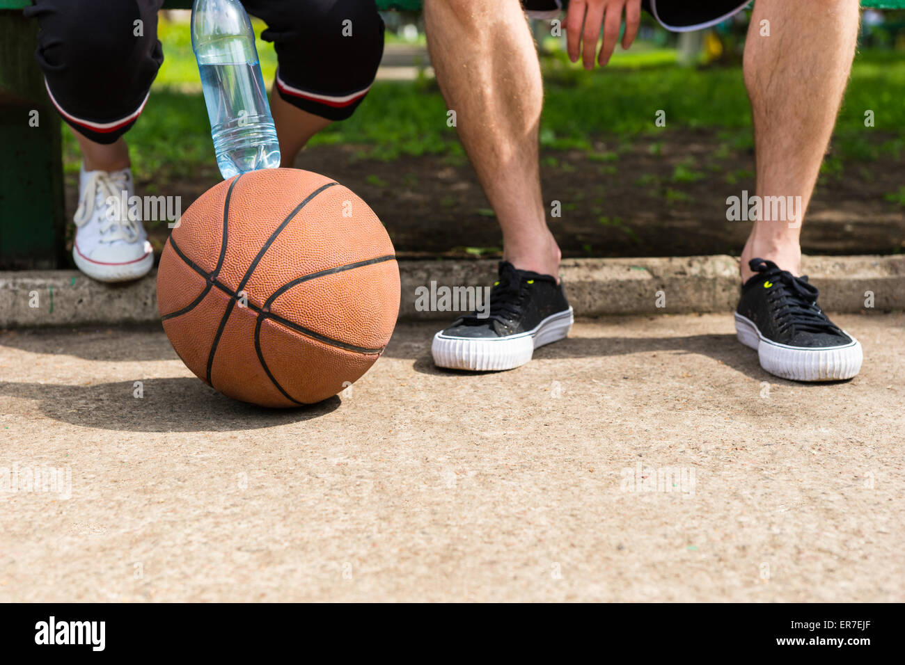 Low Angle Close Up View of Basketball on Ground at Feet of Young ...